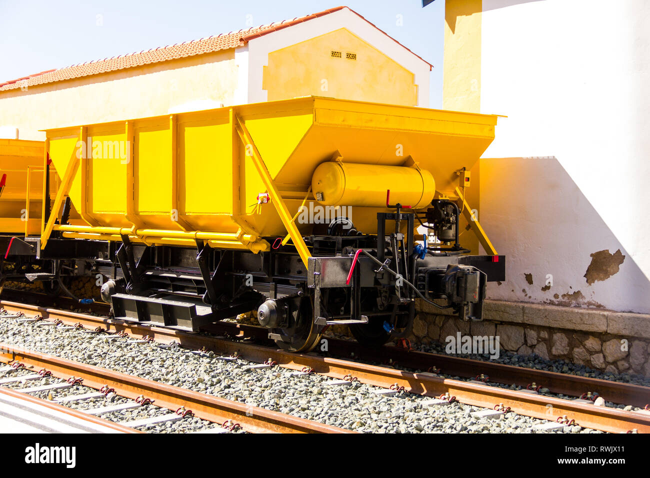 Ballast train. A large cargo yellow train at the station Stock Photo ...