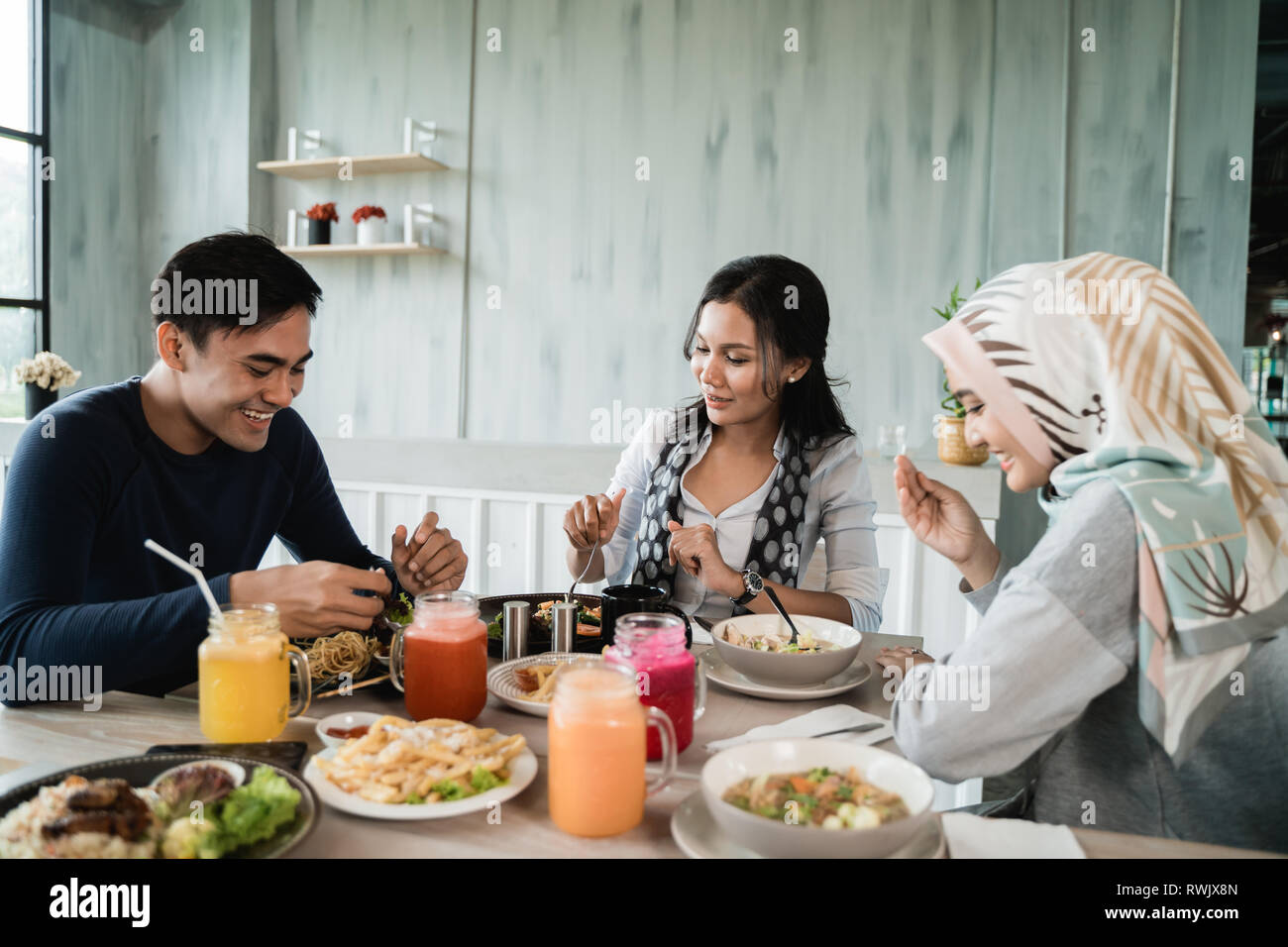 group of friends enjoy eating together Stock Photo - Alamy