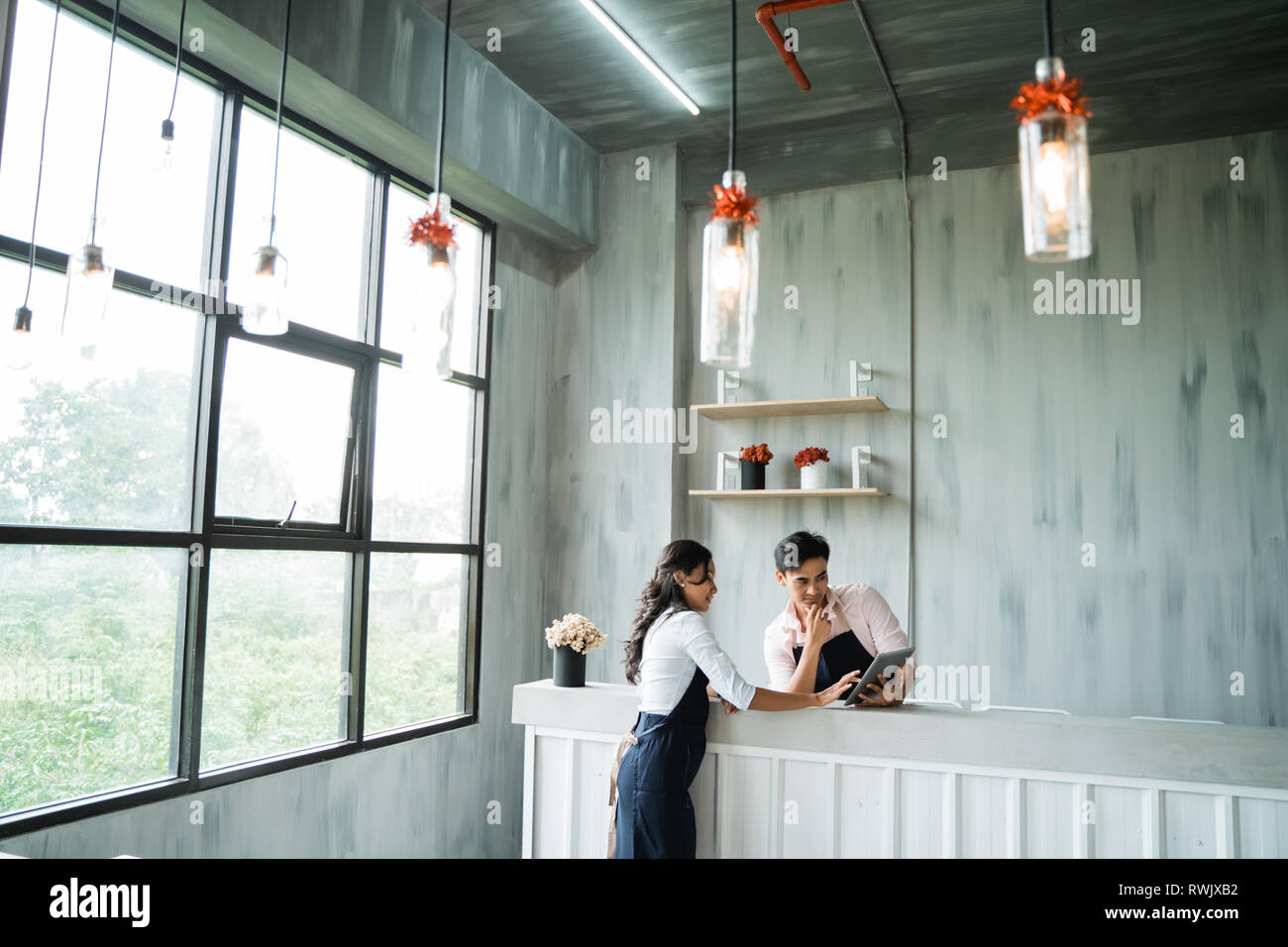 portrait two waitress standing near bar table see to the tablet Stock ...