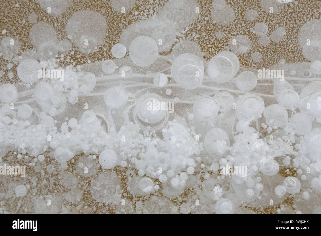 Frozen ice with a lot of ice bubbles and cracks Stock Photo - Alamy