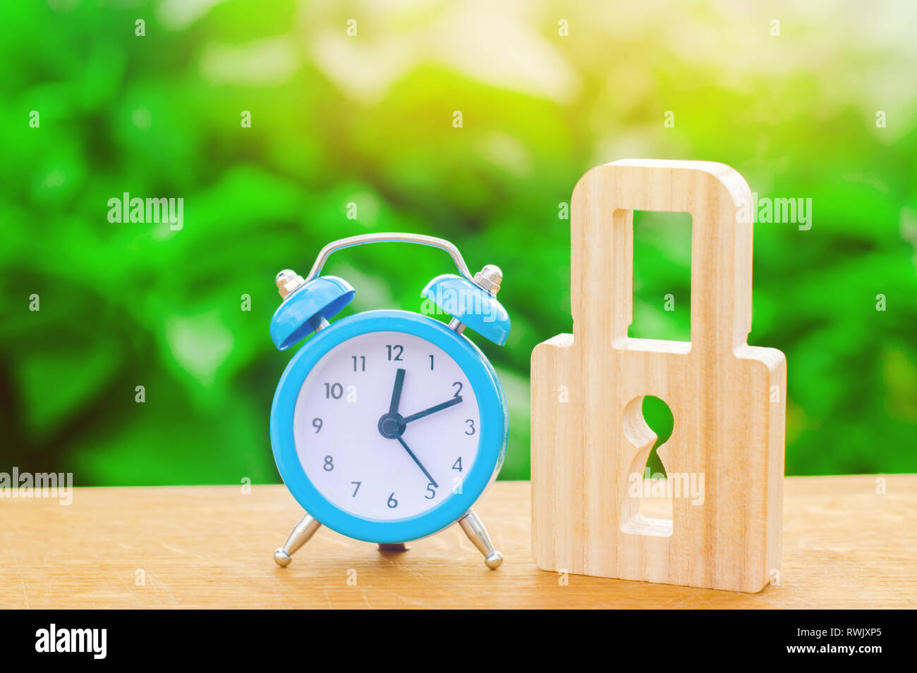 Blue alarm clock and padlock. Non-durable protection time-tested ...