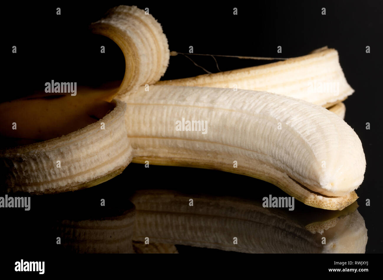 Banana on a black background with the mirror reflection. A modern ...