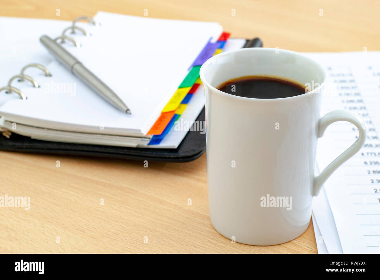 office desk table with cup of coffee and planning agenda for input the ...