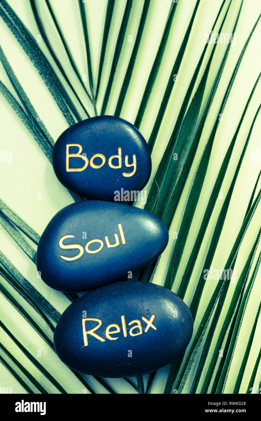 body, soul, relax words written on black lava stones Stock Photo - Alamy