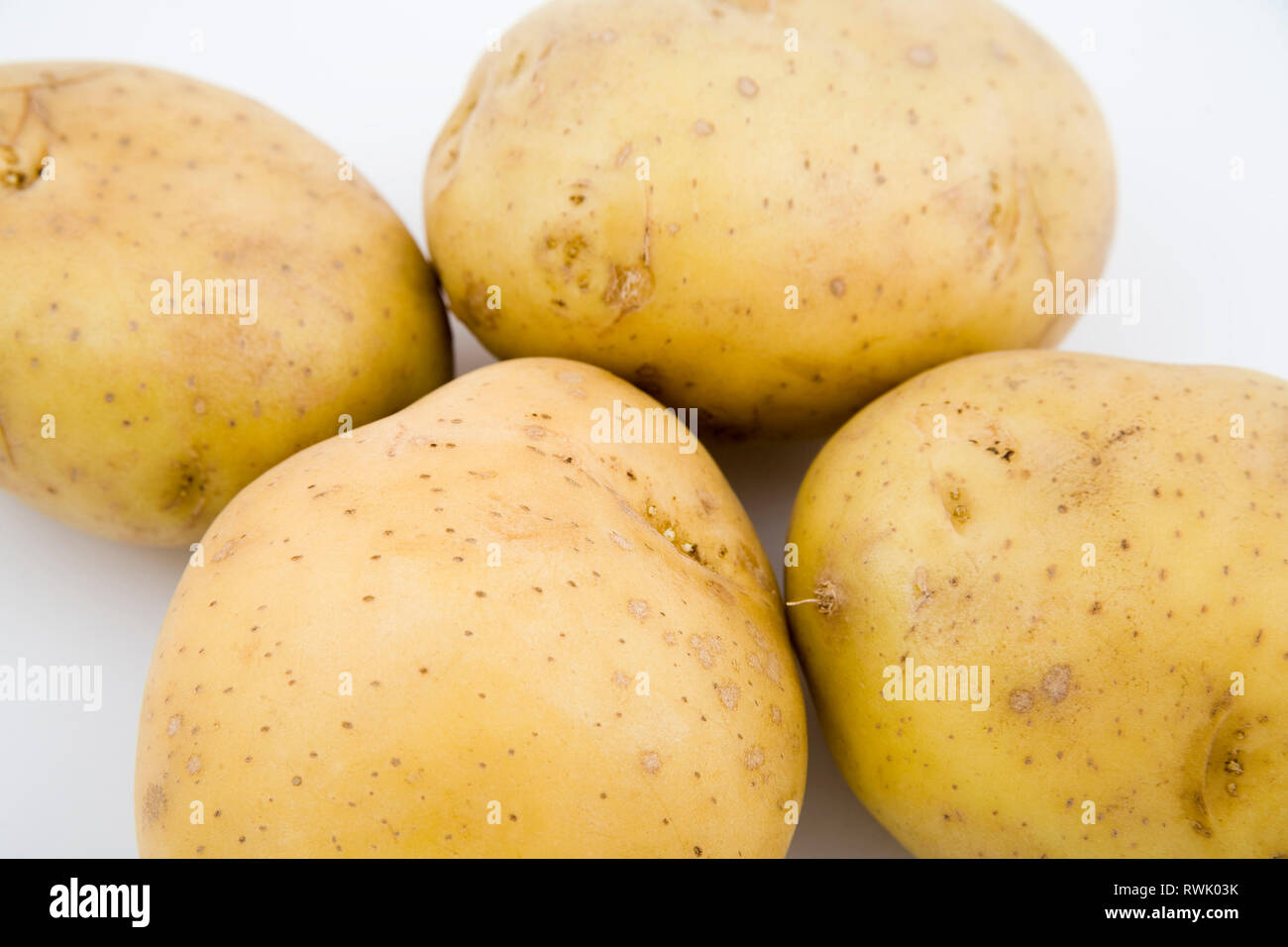 four young potatoes with gentle shadow on natural background Stock ...