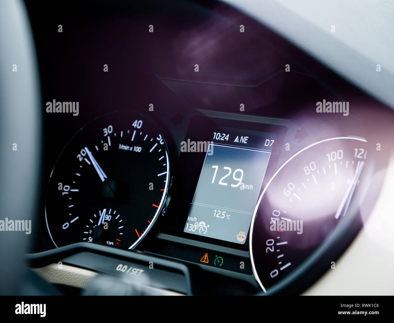 Car dashboard with speedometer showing 129 kilometres per hour fast ...