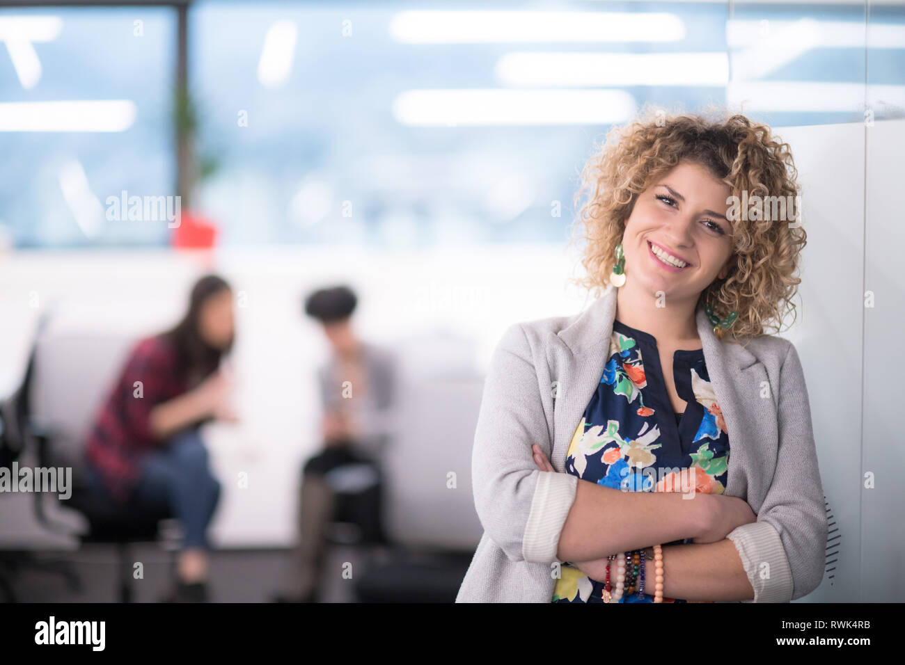 Portrait of successful female software developer with a curly hairstyle ...