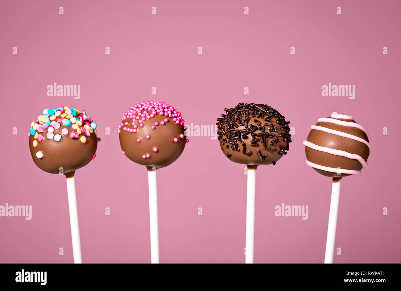 Chocolate cake pops on a pink background Stock Photo - Alamy