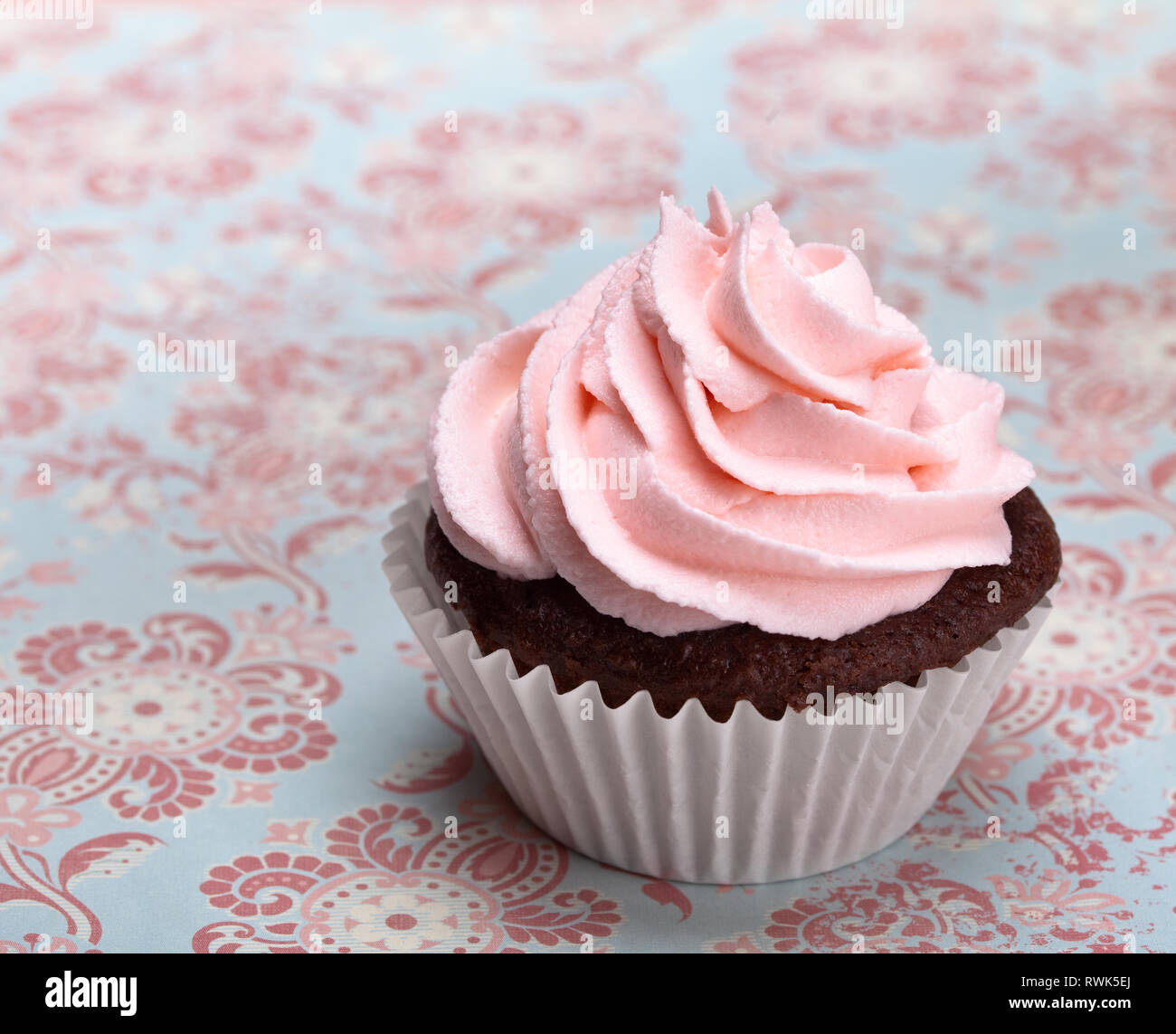 Chocolate cupcake with pink buttercream icing Stock Photo - Alamy