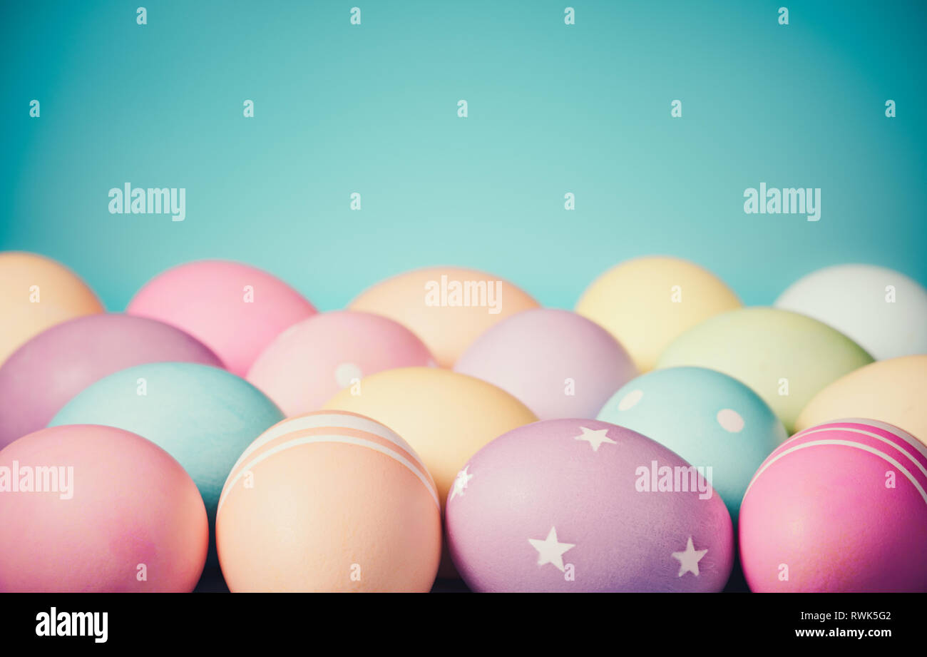 Colorful Easter Eggs border on a teal blue background with subtle ...