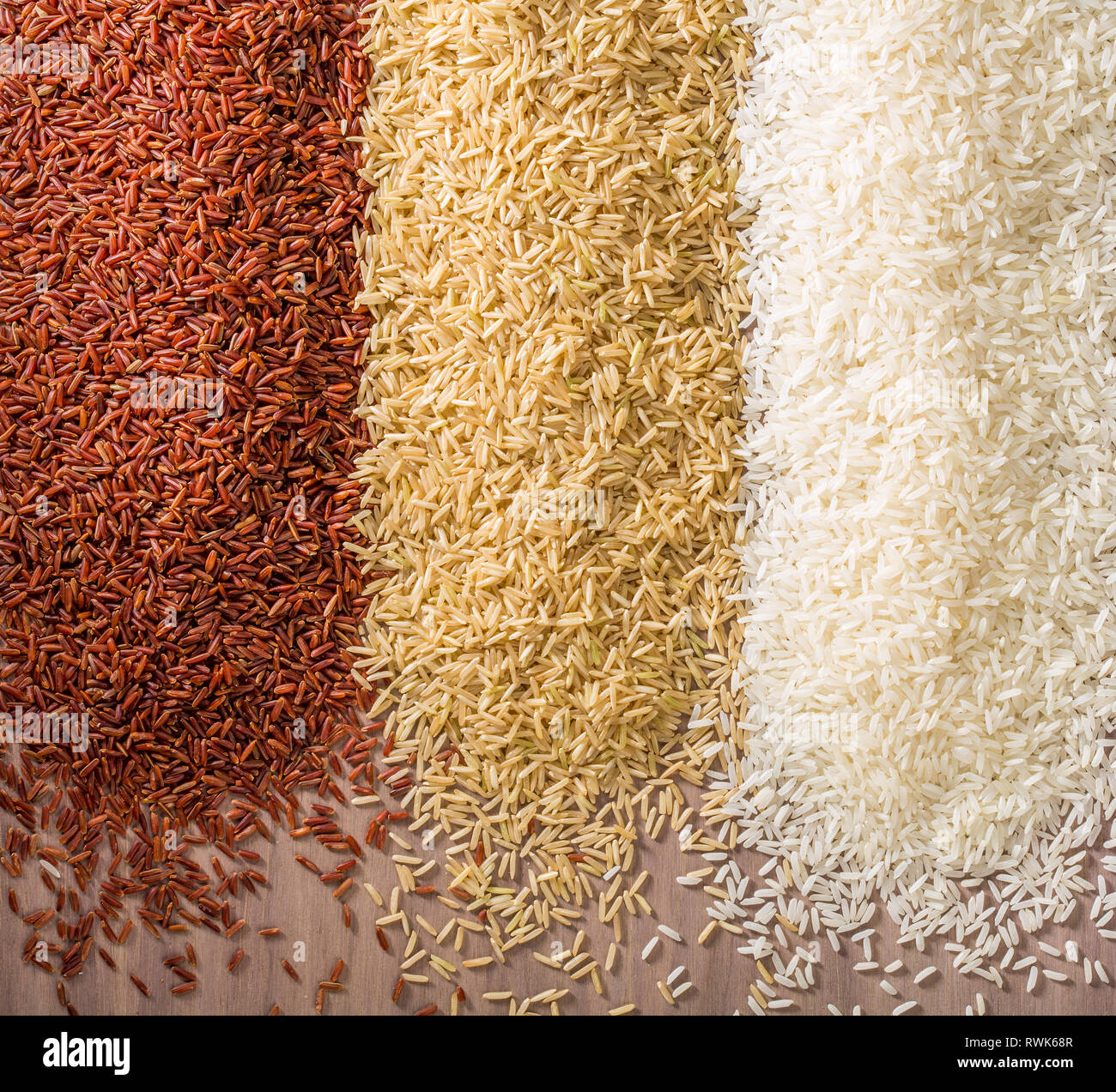 close up of a variety of long grain rice; red, Brown and white Stock ...