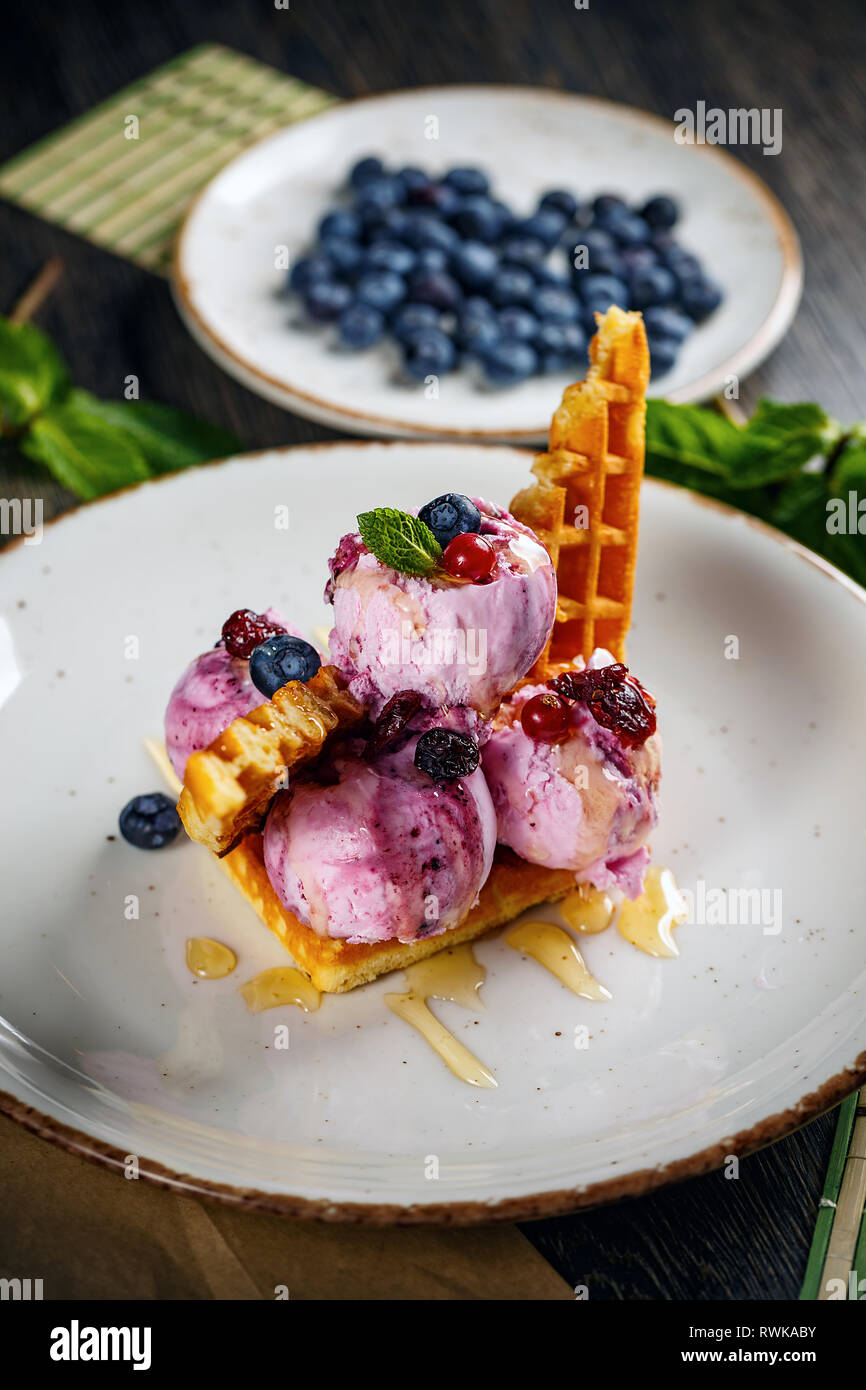 Forest fruit ice cream decorated with delicious waffle and honey ...