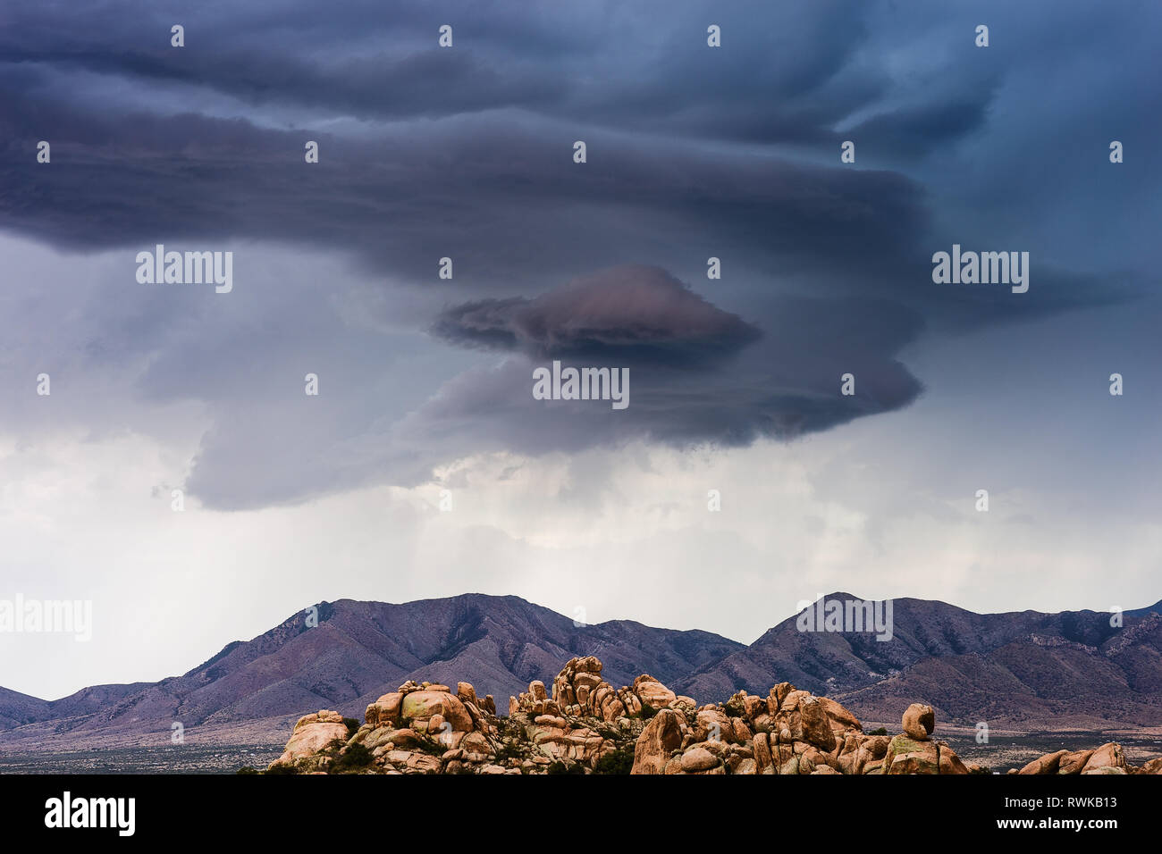 A high-based supercell thunderstorm spins above the Dragoon Mountains ...
