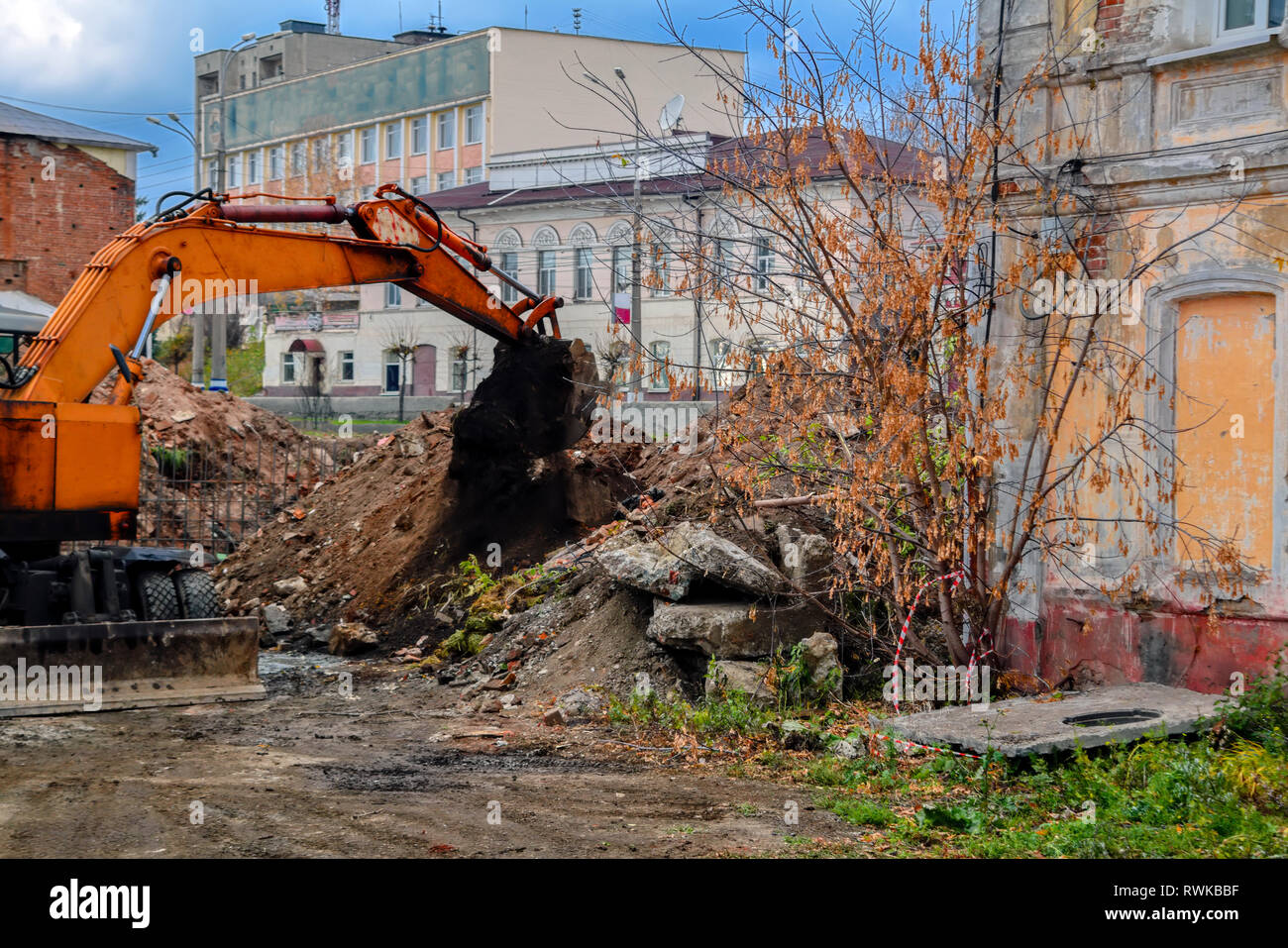 excavator at a construction site for the restoration of old urban ...