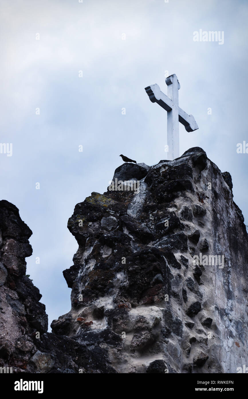 White cross on stone ruins with dramatic blue sky in Hermano Pedro ...