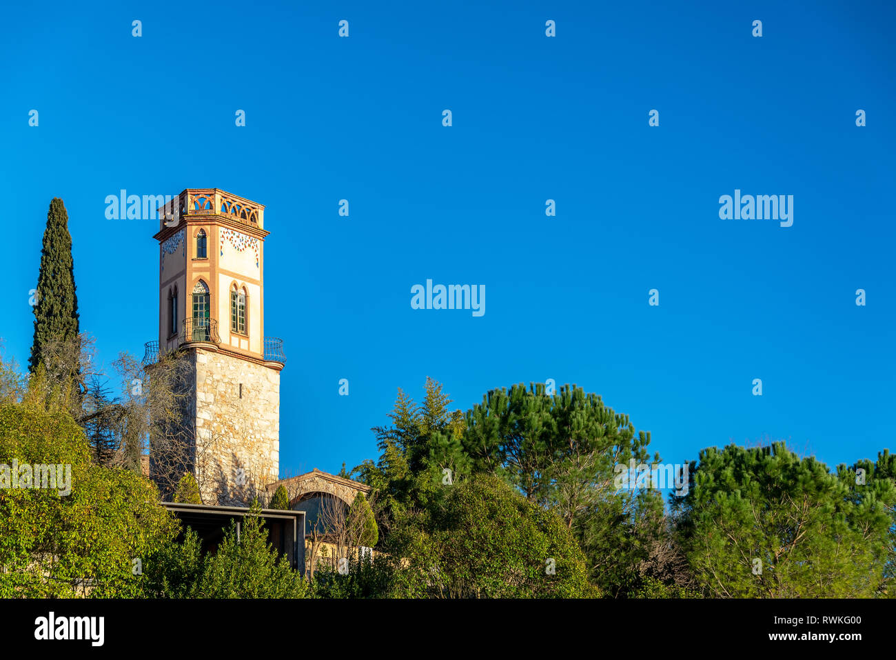 Historic tower with trees and a beautiful blue sky in Girona, Spain ...