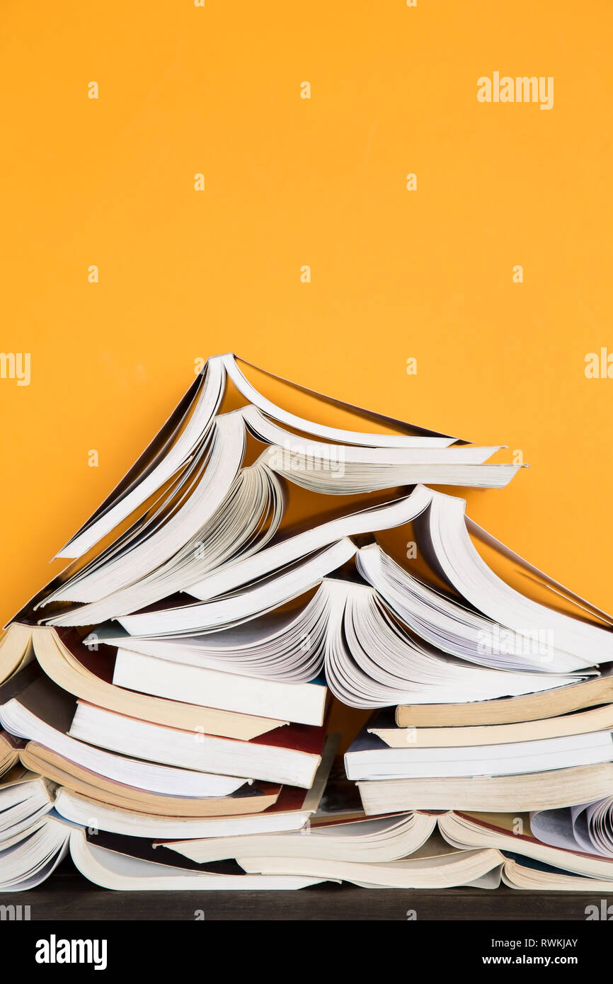 Pile of books over yellow background Stock Photo - Alamy