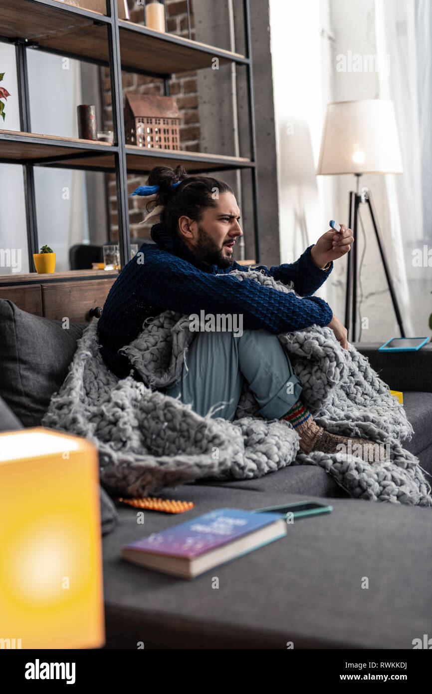 Sick man checking body temperature hi-res stock photography and images ...