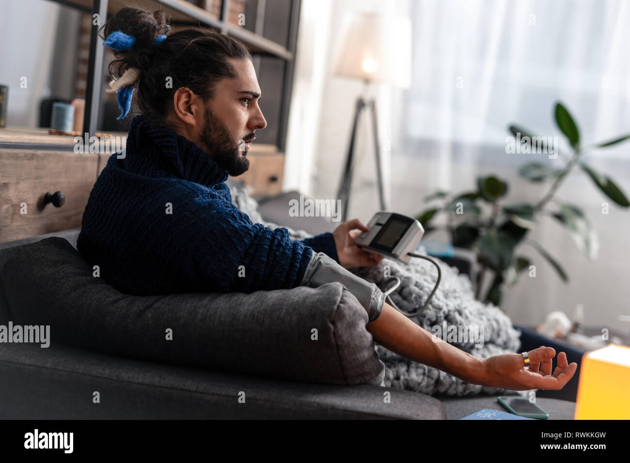 Nice young man worrying about his health Stock Photo - Alamy