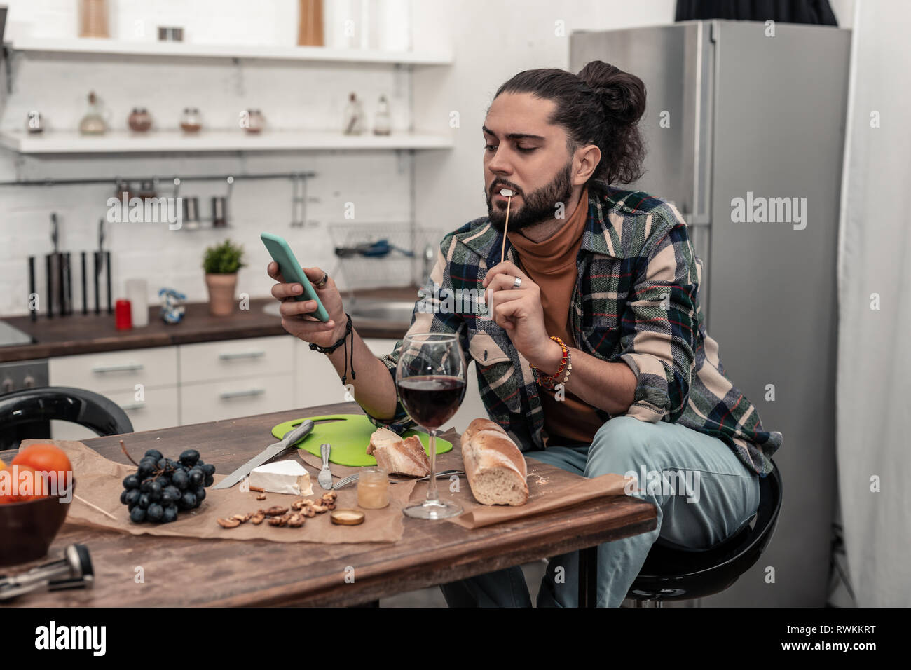 Pleasant nice young man eating delicious cheese Stock Photo - Alamy