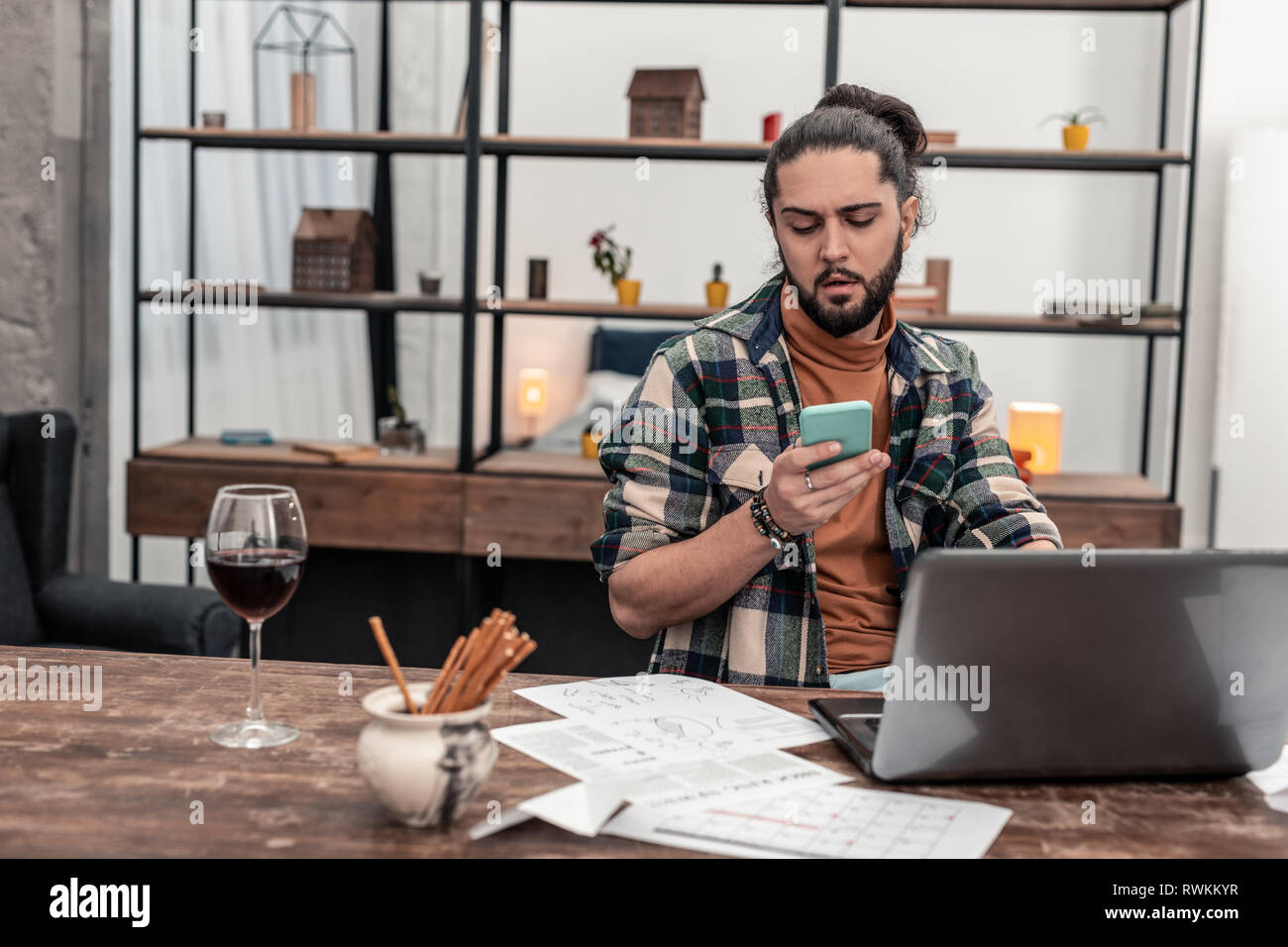 Serious nice young man typing a message Stock Photo - Alamy