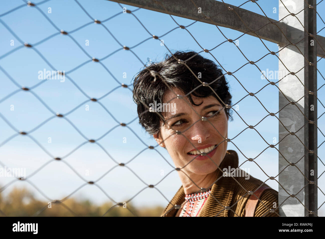 Woman behind fence hi-res stock photography and images - Alamy