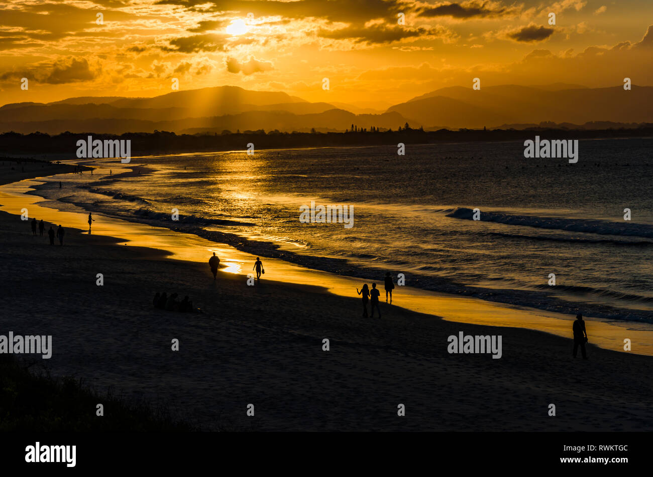 People at the beach during sunset Stock Photo - Alamy