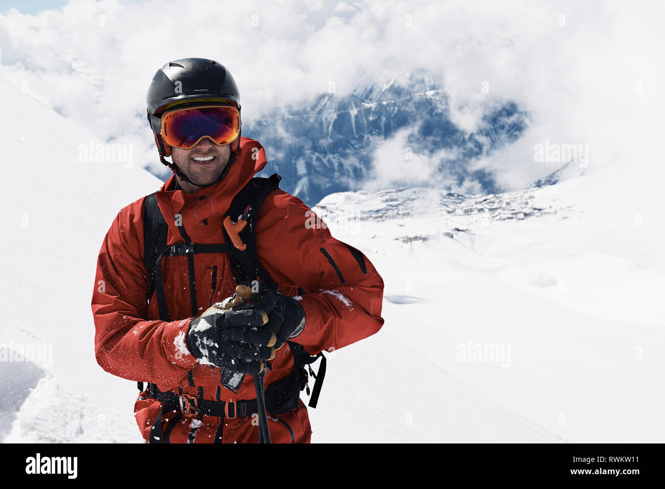 Male skier on mountainside, portrait, Alpe-d'Huez, Rhone-Alpes, France ...