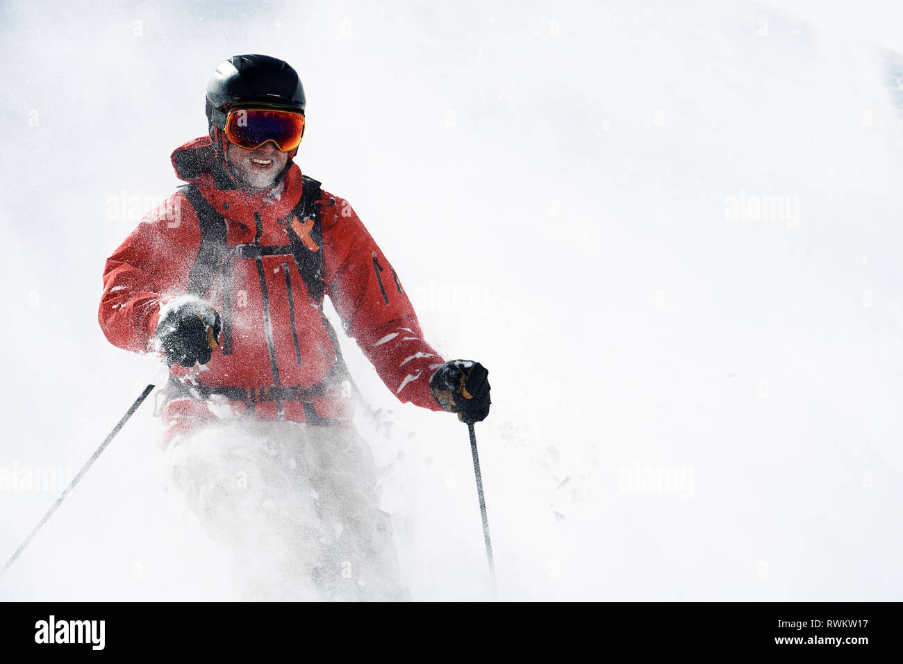 Male skier covered in powder snow on mountainside Alpe-d'Huez, Rhone ...