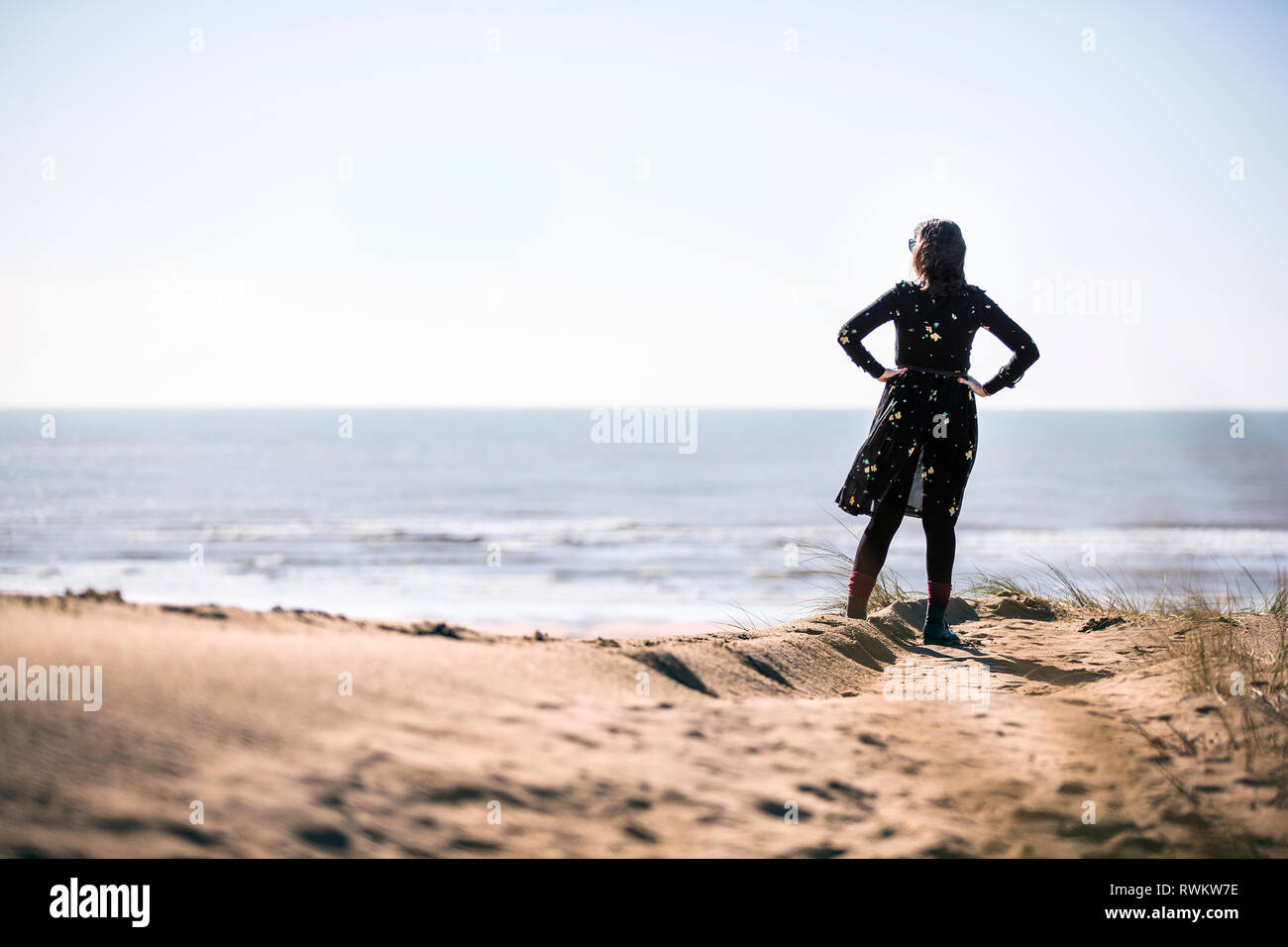 Woman looking out to sea hi-res stock photography and images - Alamy