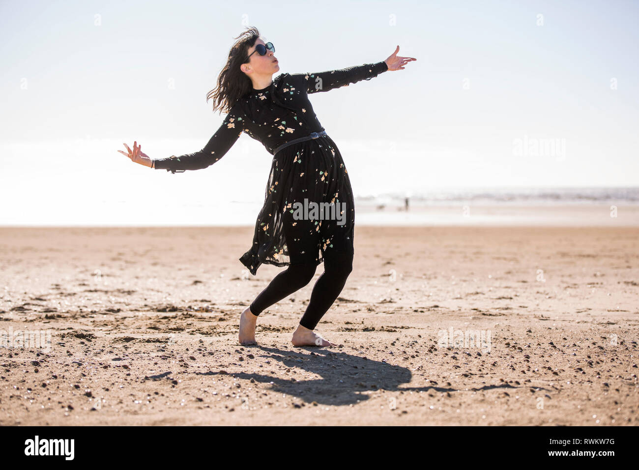 Woman dancing on beach Stock Photo - Alamy
