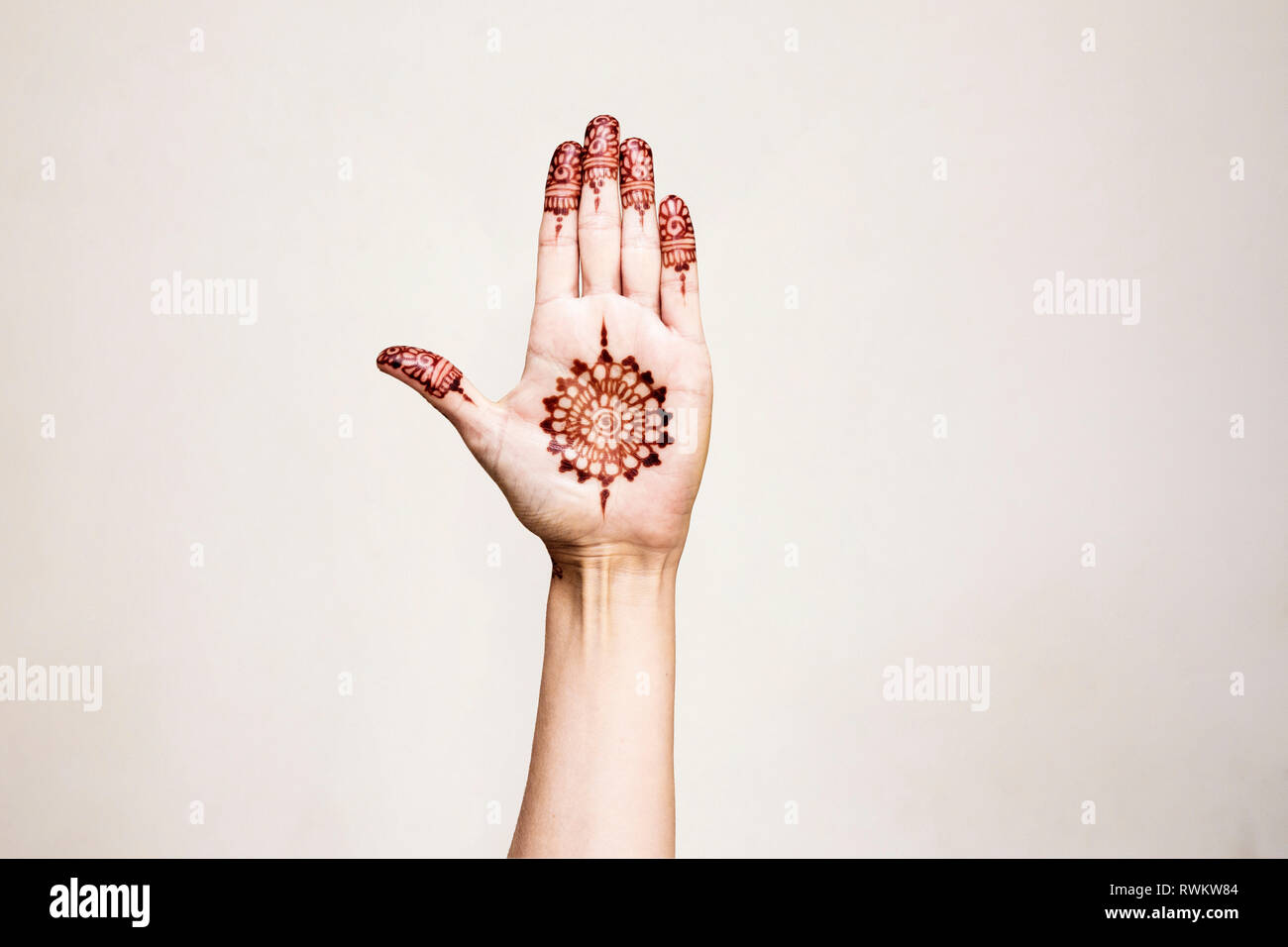 Hand with henna tattoo making gesture Stock Photo - Alamy