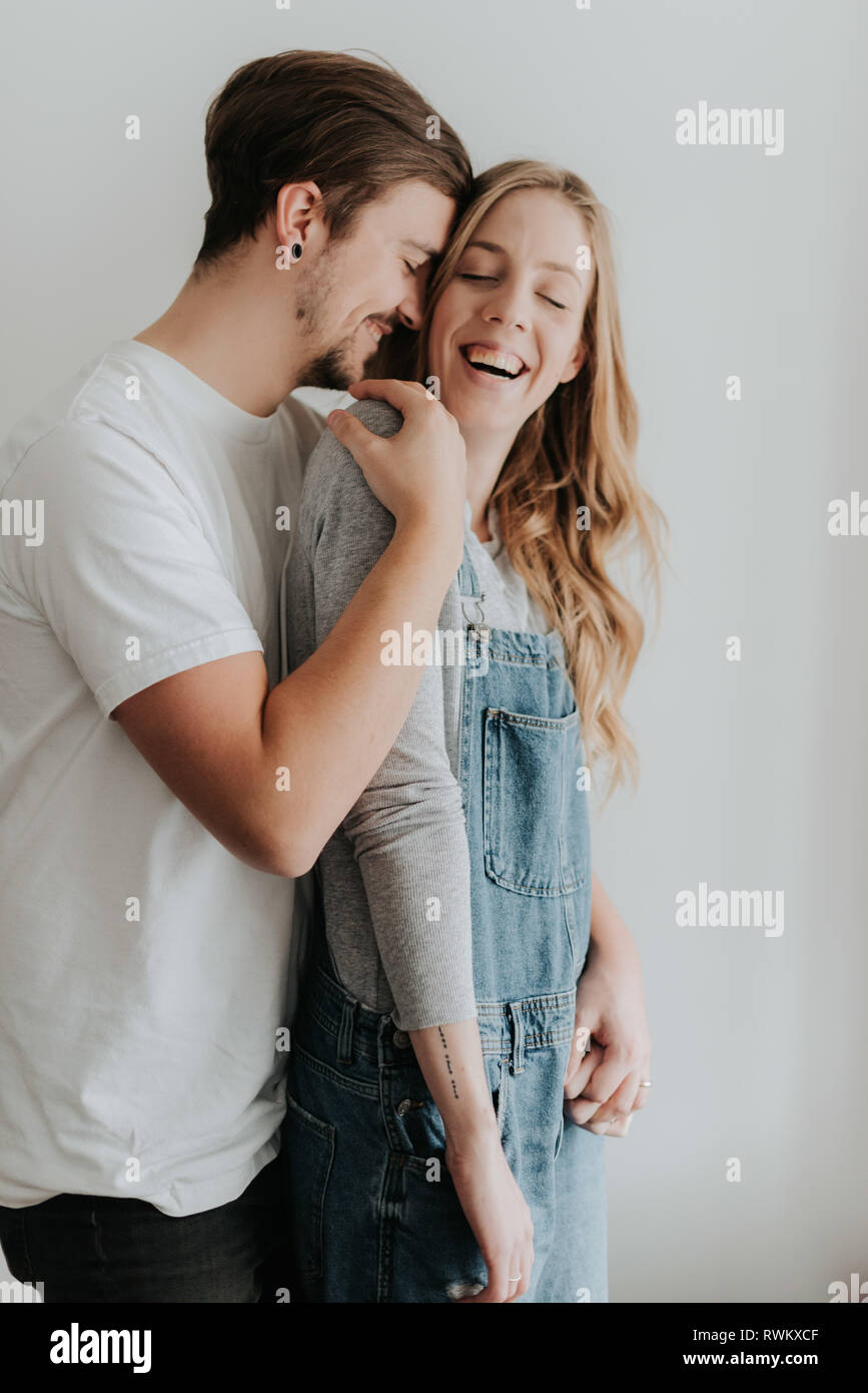 Happy couple laughing and hugging Stock Photo - Alamy