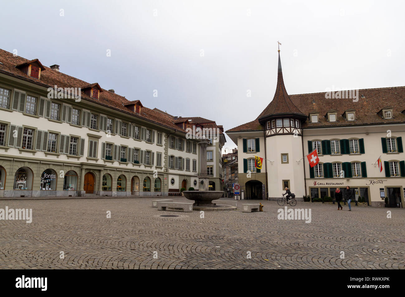 City hall square with old buildings and fountain in the center of Thun ...
