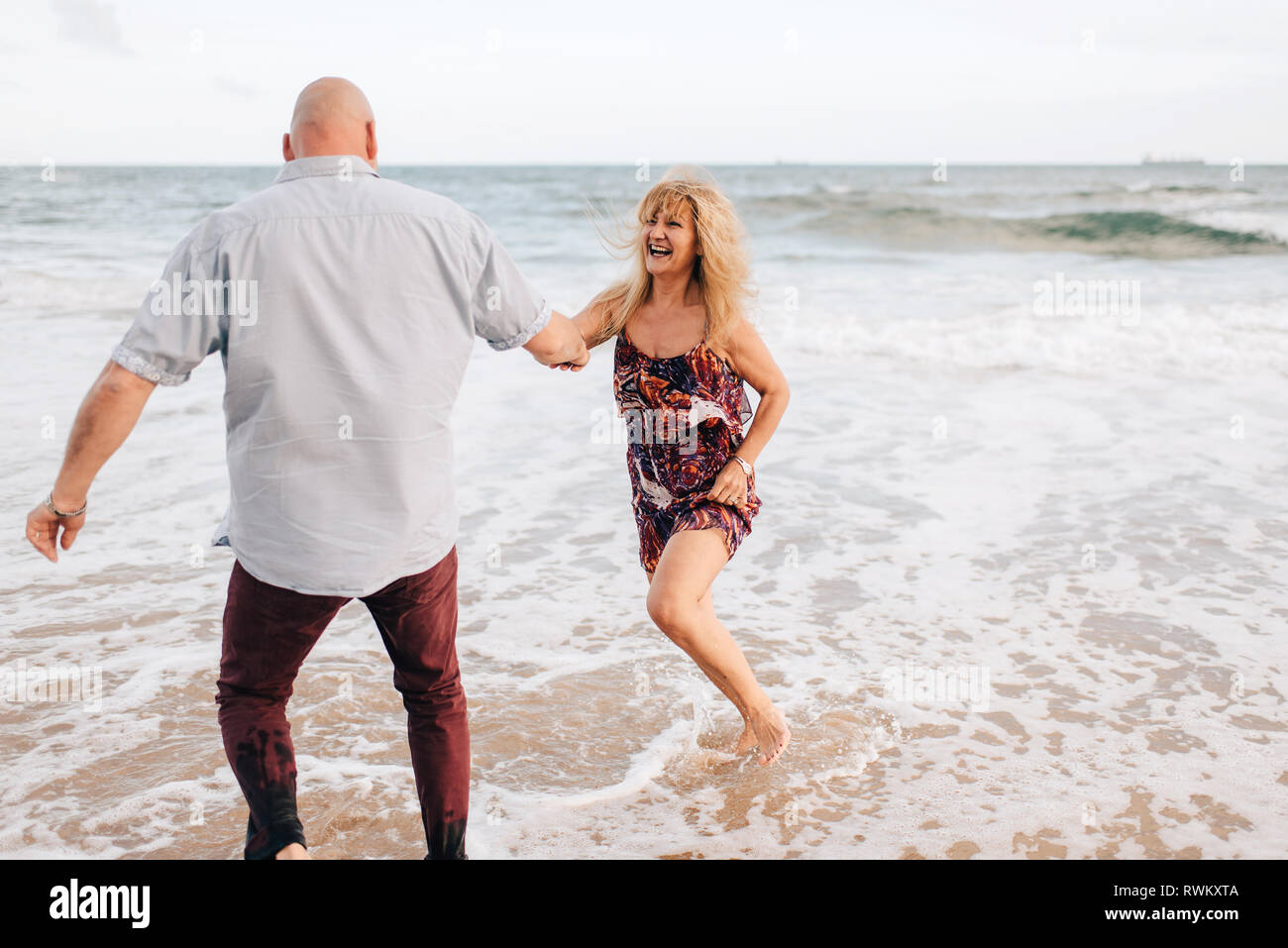 Couple having fun on beach hi-res stock photography and images - Alamy