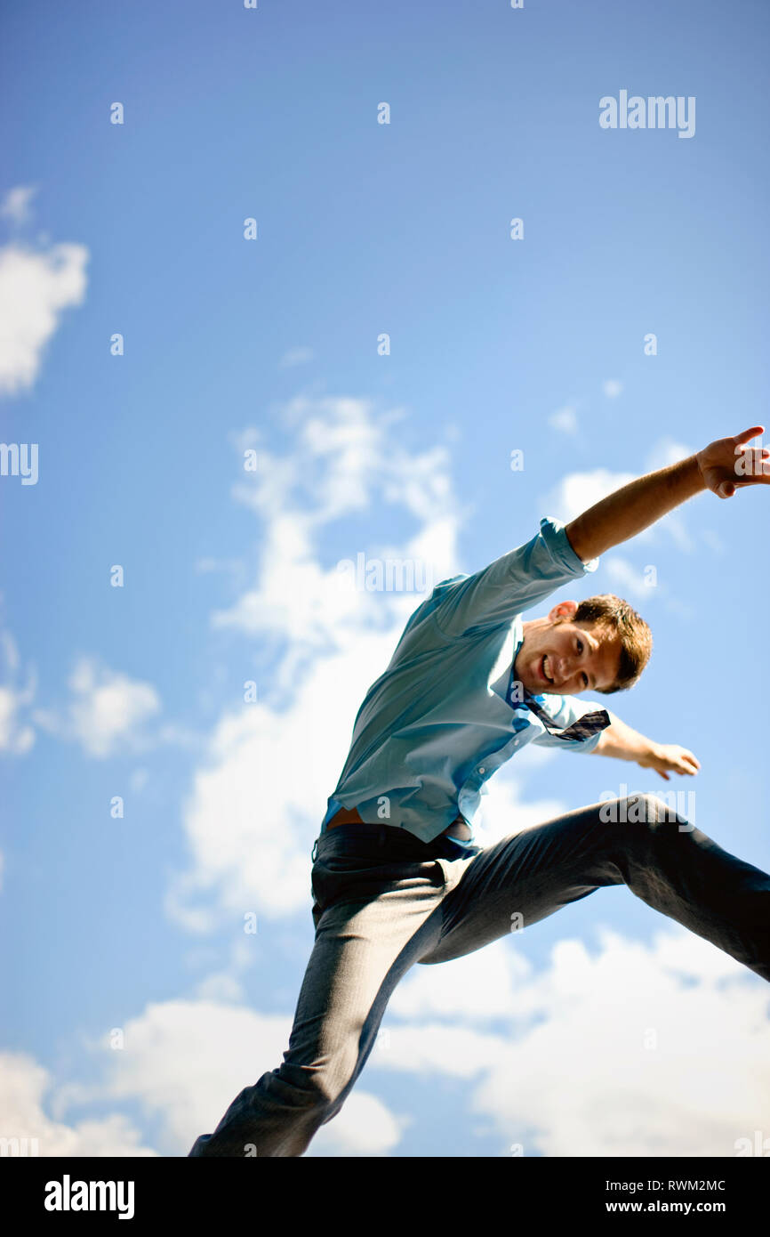 Low angle view of a man jumping for joy Stock Photo - Alamy