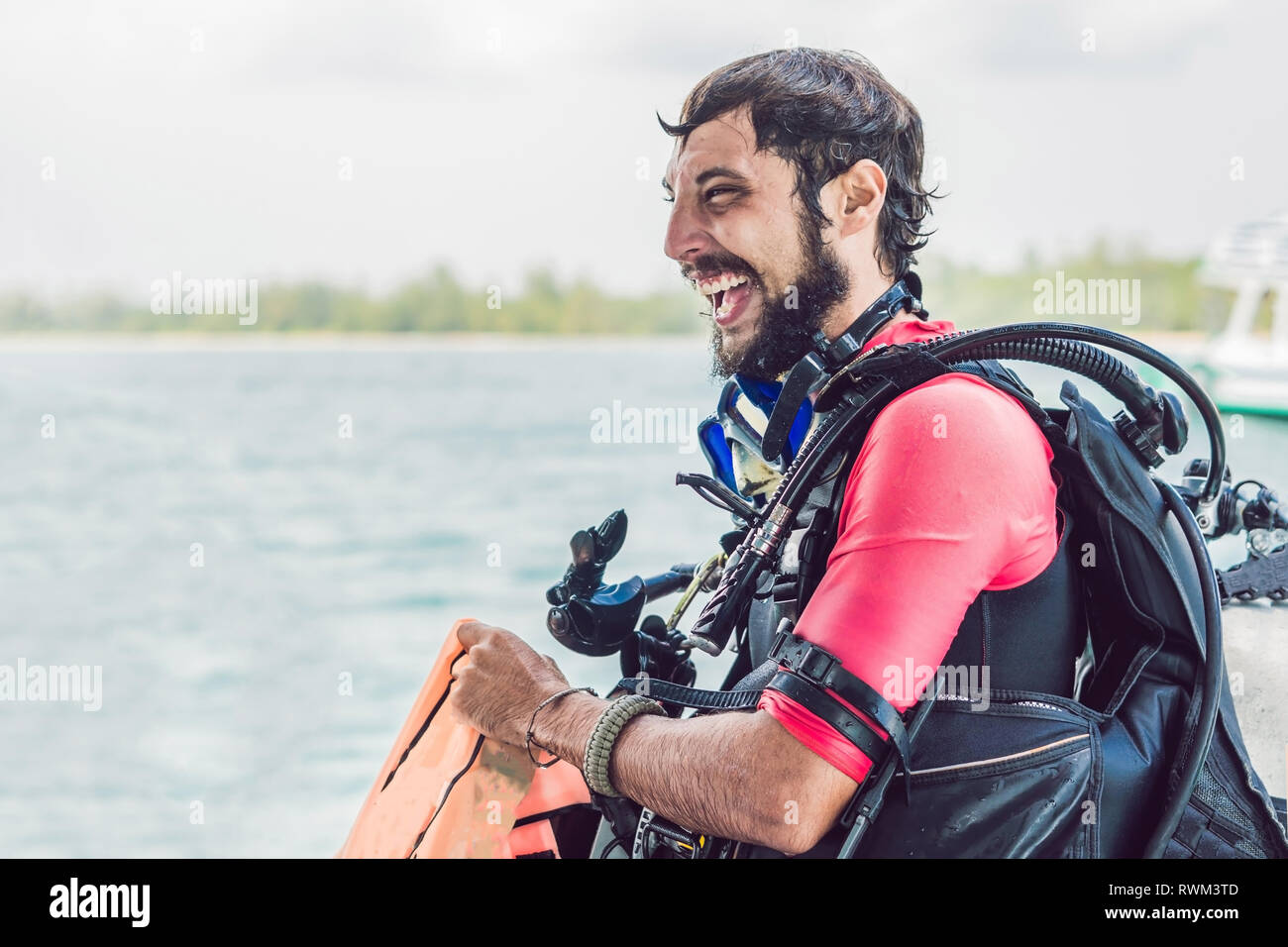 Happy diver returns to the ship after diving Stock Photo - Alamy