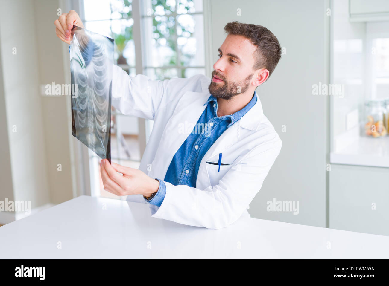 Doctor man looking at x-ray radiography doing body examination Stock ...