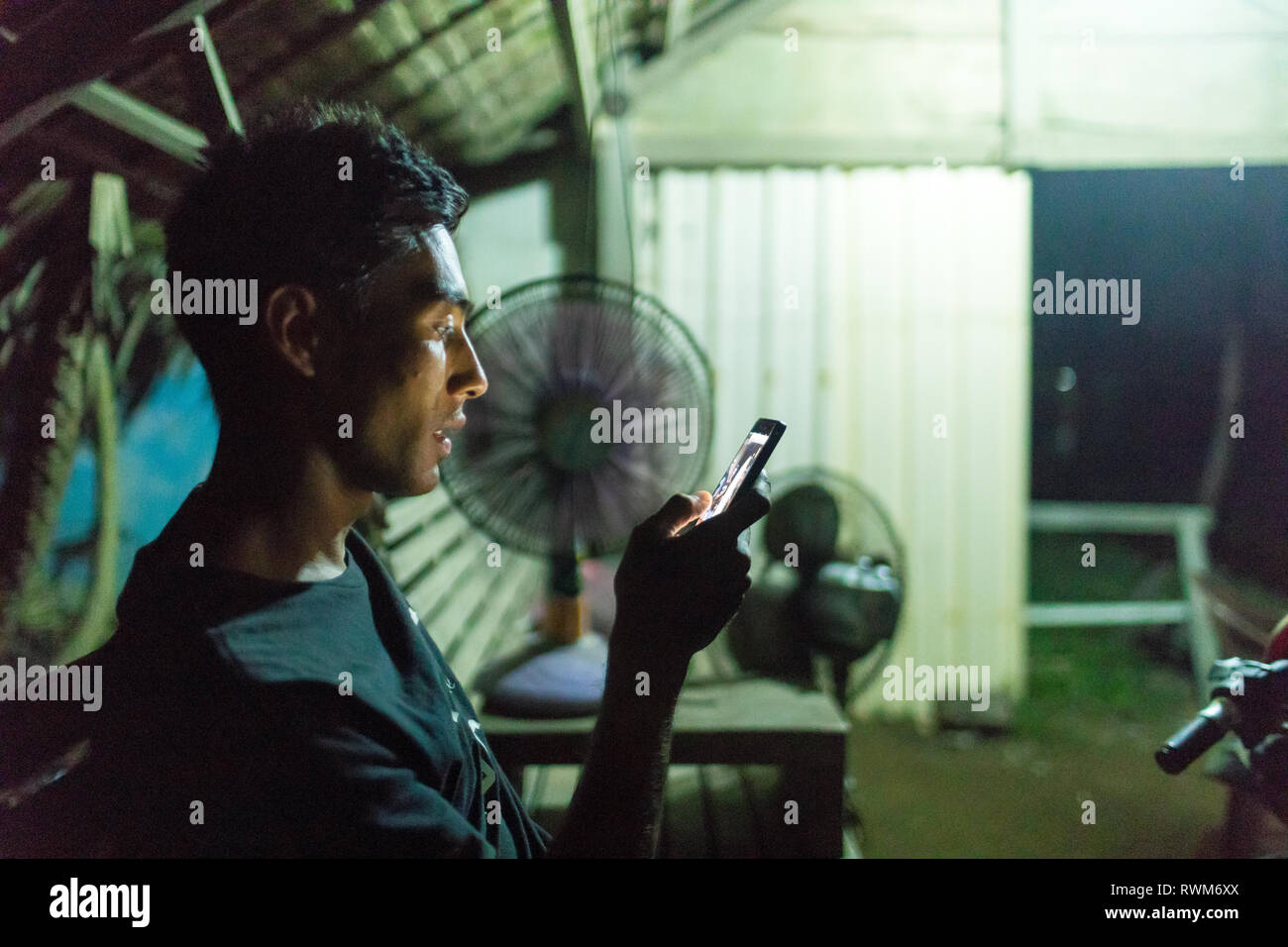 Man texting by fans, Abulug, Cagayan, Philippines Stock Photo - Alamy