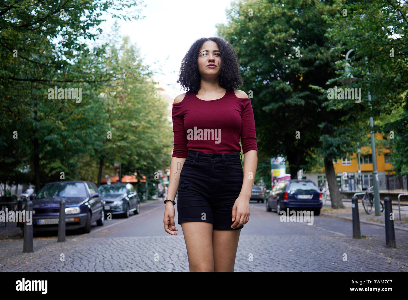 Young woman in middle of street, Berlin, Germany Stock Photo - Alamy