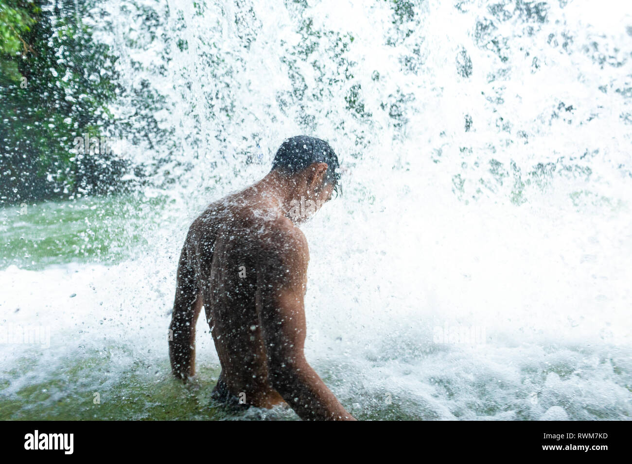 Man under waterfall hi-res stock photography and images - Alamy