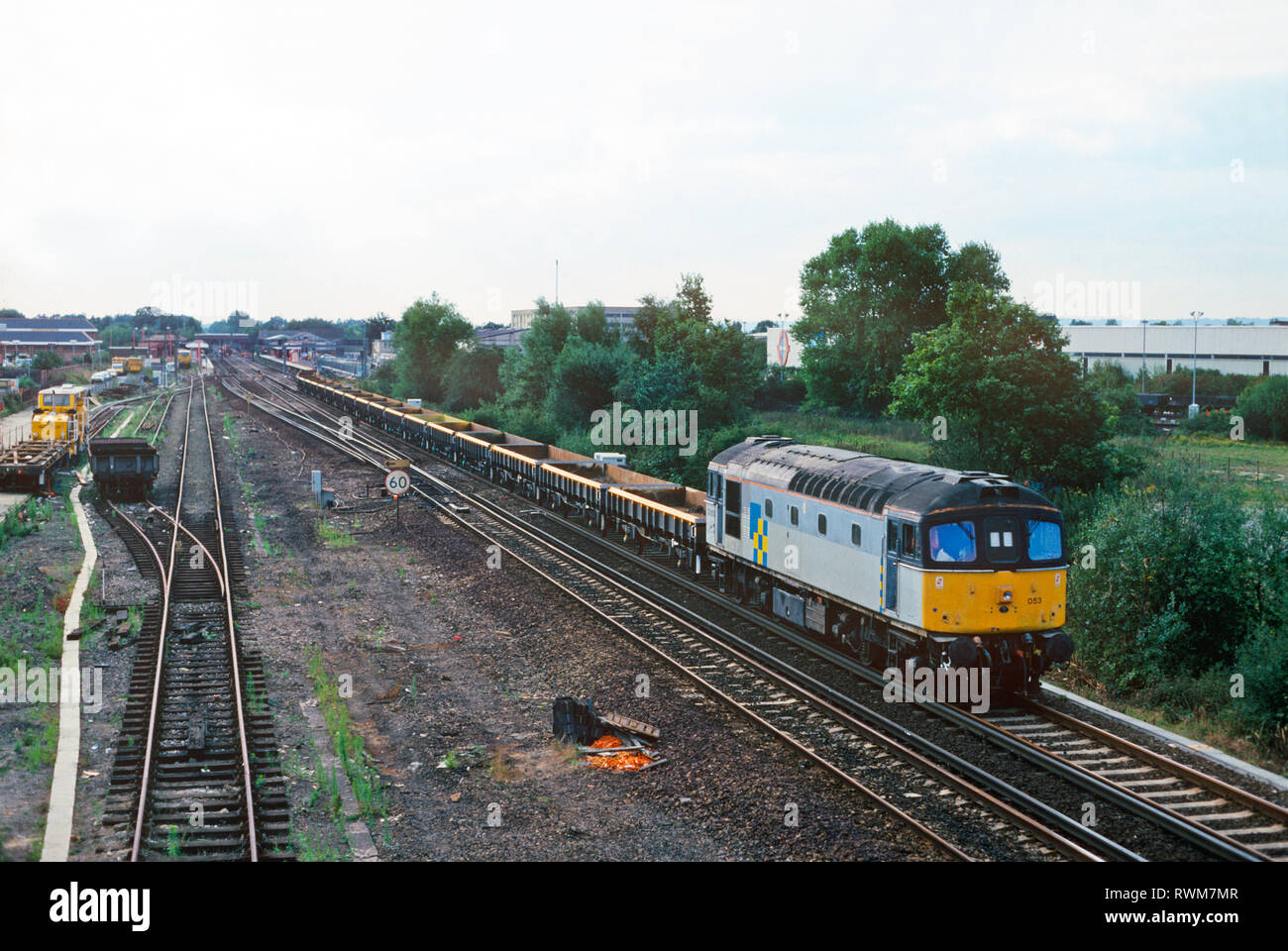 A class 33 diesel locomotive number 33053 departs Paddock Wood with a ...