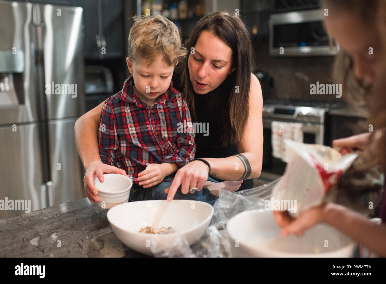 Children helping mother in kitchen Stock Photo - Alamy