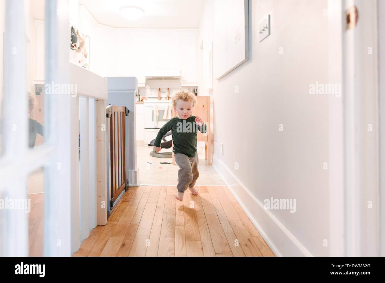 Boy running along corridor Stock Photo - Alamy