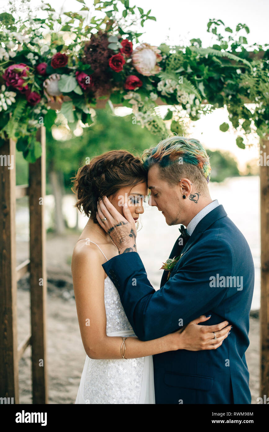 Romantic bride and groom face to face on lakeside Stock Photo - Alamy