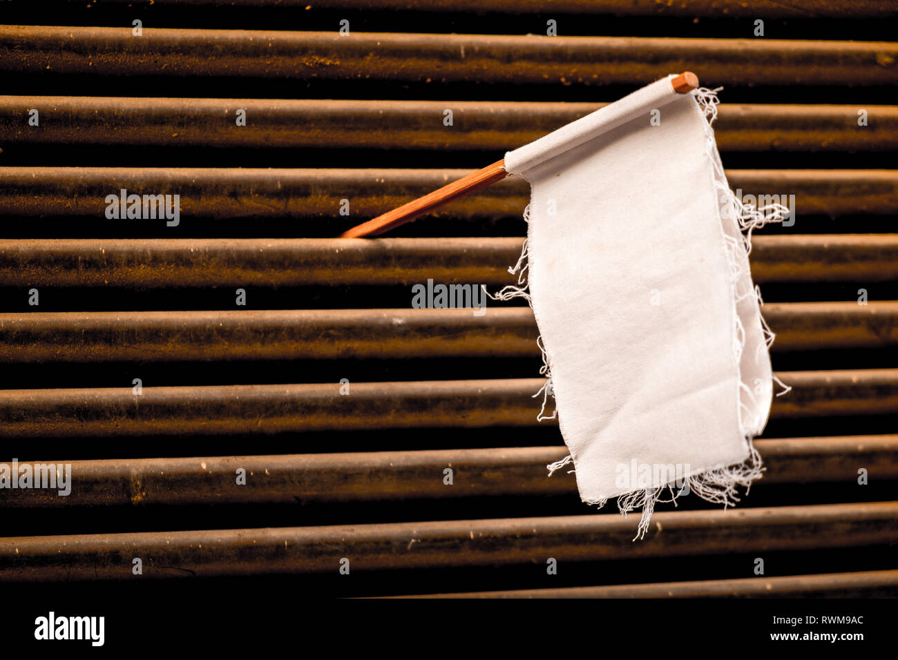 Ragged cloth being waved as a white flag Stock Photo - Alamy