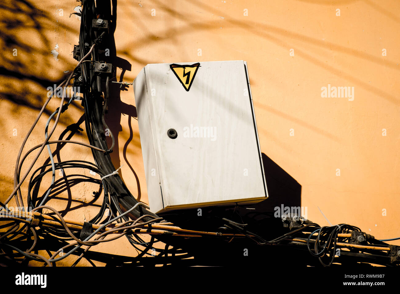 Facade with a complete mess of unsafe wiring Stock Photo - Alamy
