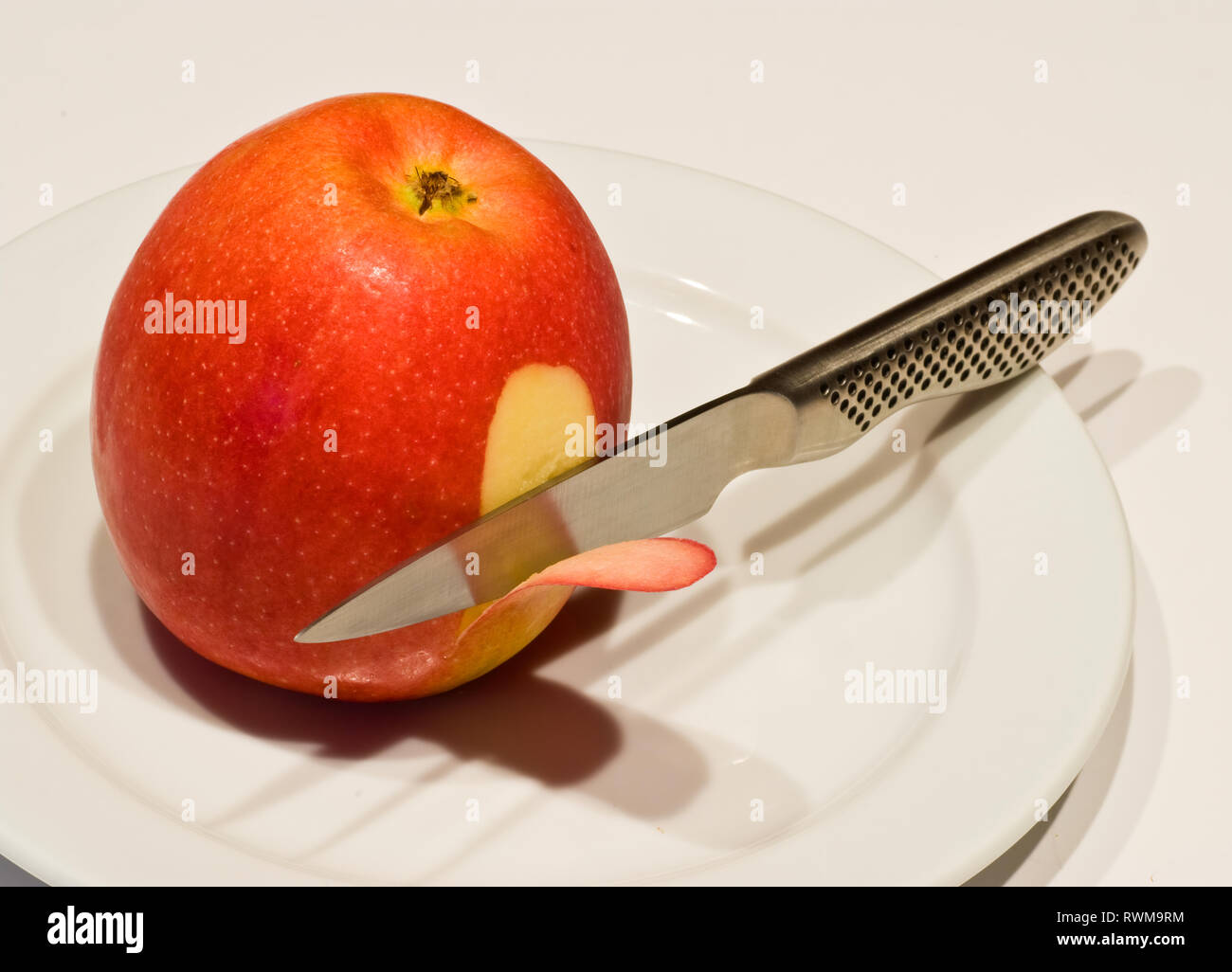 Fuji apple being peeled with knife Stock Photo - Alamy