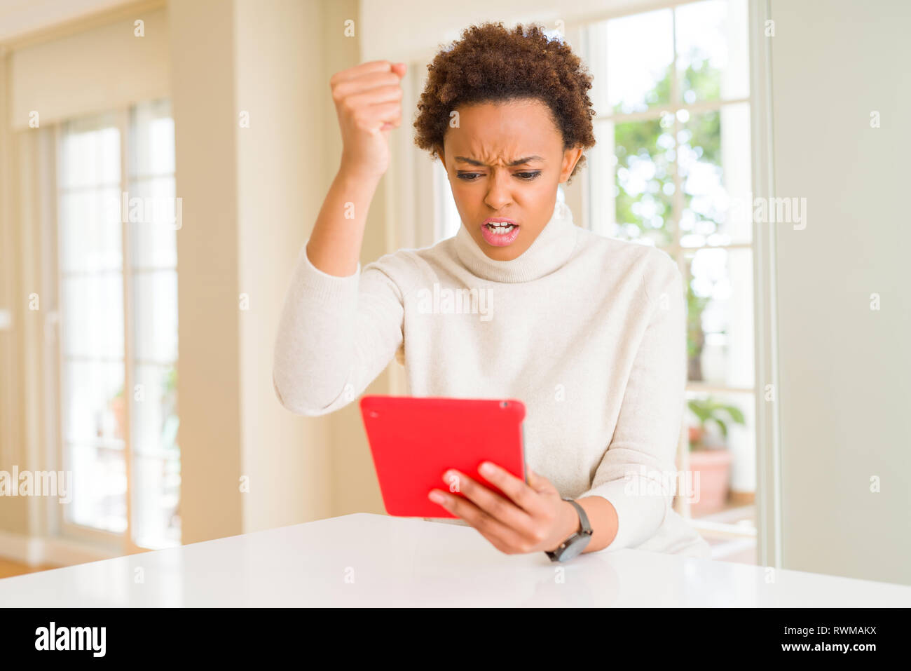 Young african american woman using tablet annoyed and frustrated ...