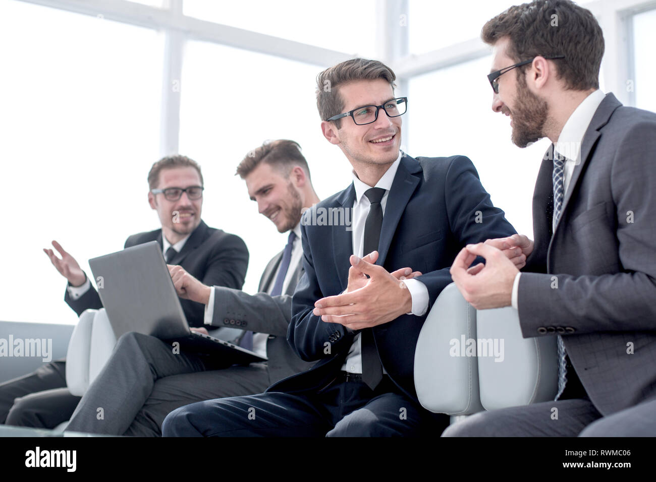 group of business people talking sitting in the office waiting room ...